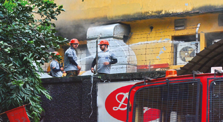 Fire at De'z Medical factory, coughing while covering nose and mouth ...