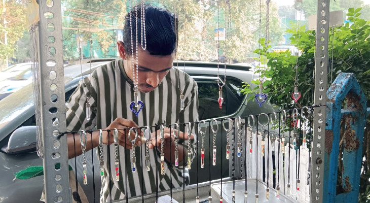Rehan, who is illiterate, draws name on rice grains